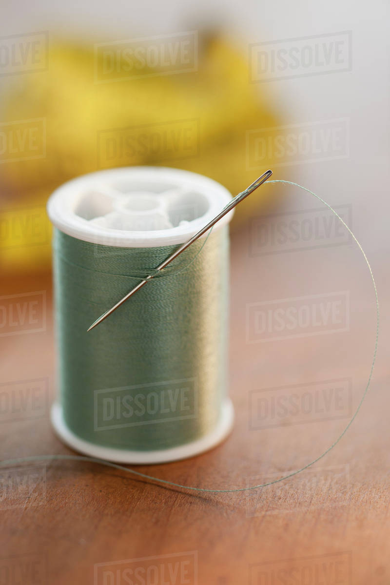 Close-up of green thread spool with needle - Royalty-free Stock Photo ...