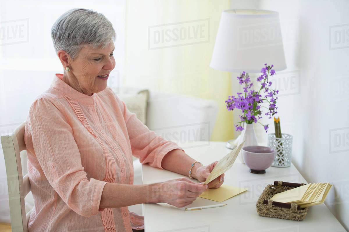 Senior woman writing letter - Stock Photo - Dissolve