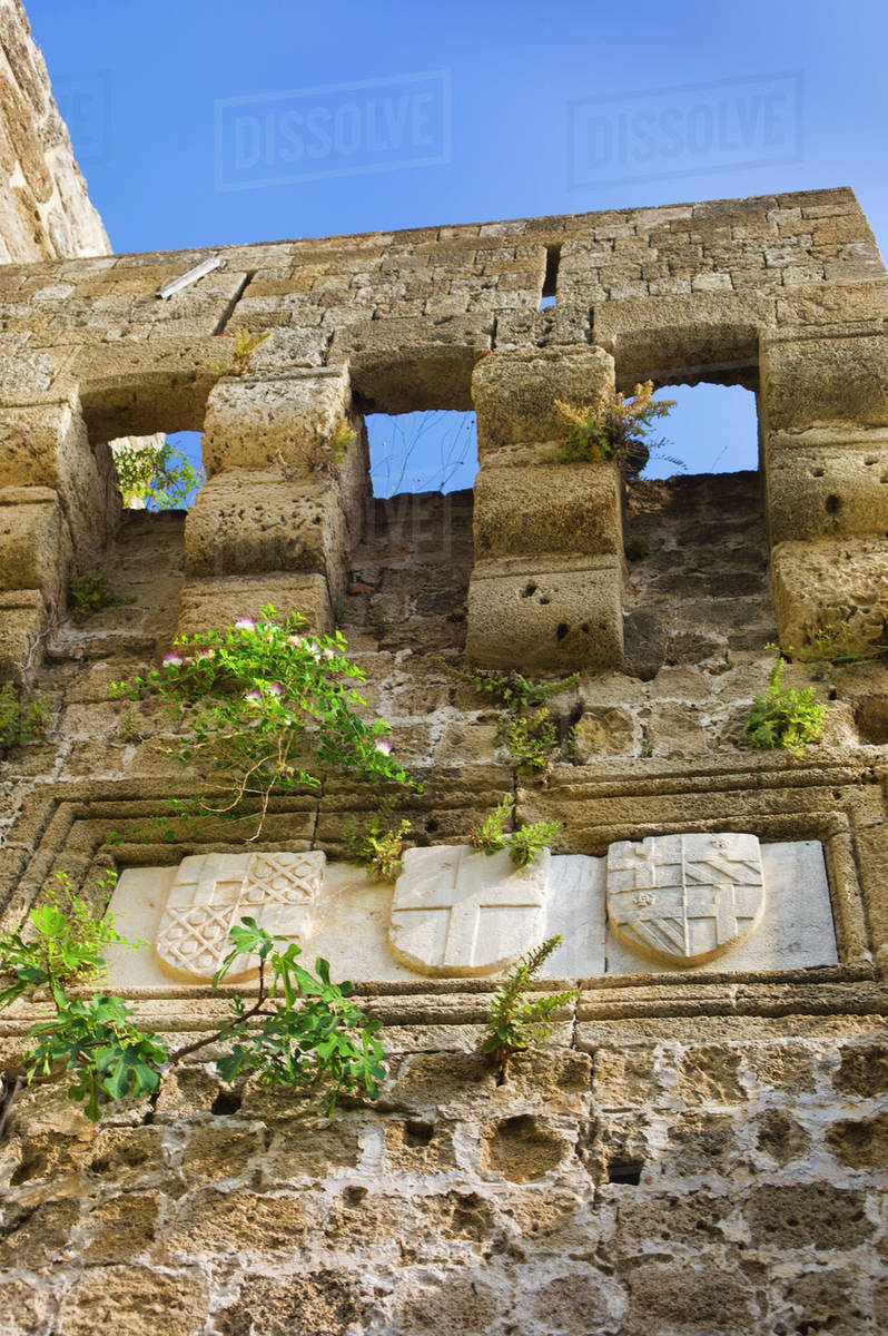 Greece, Rhodes, Medieval fortified wall with stone shields - Royalty ...
