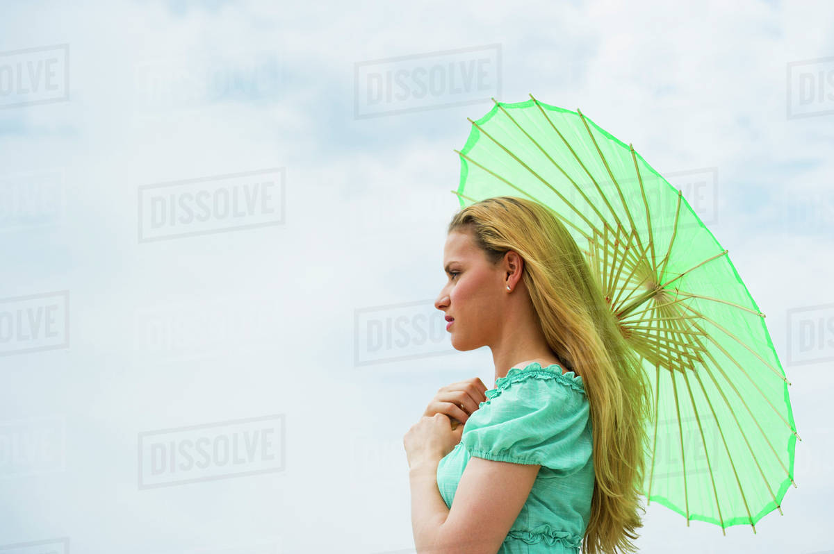 Woman holding parasol - Royalty-free Stock Photo | Dissolve