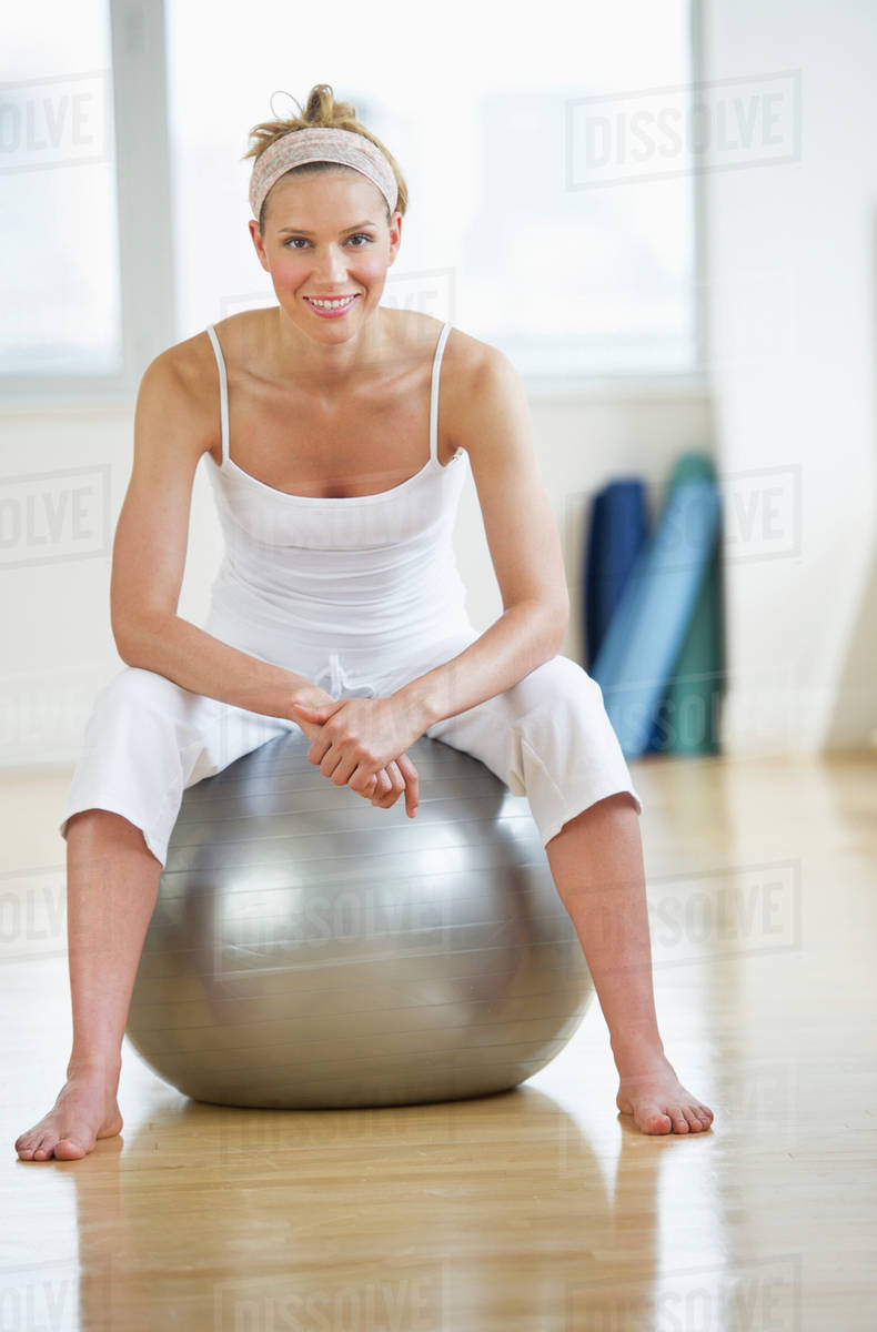 Woman sitting on fitness ball - Royalty-free Stock Photo | Dissolve