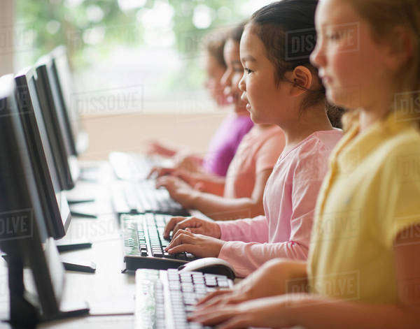Four girls (6-9) using computers - Royalty-free Stock Photo | Dissolve