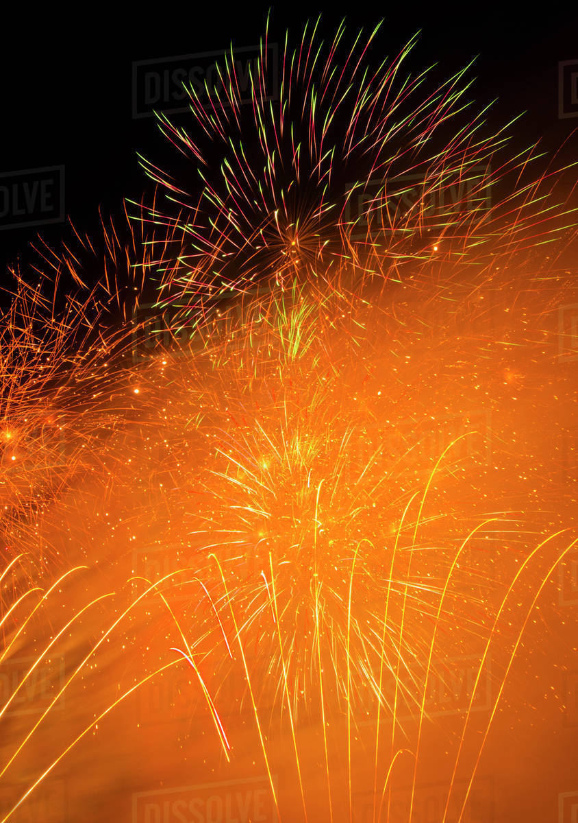 Fireworks explosion against night sky - Royalty-free Stock Photo | Dissolve