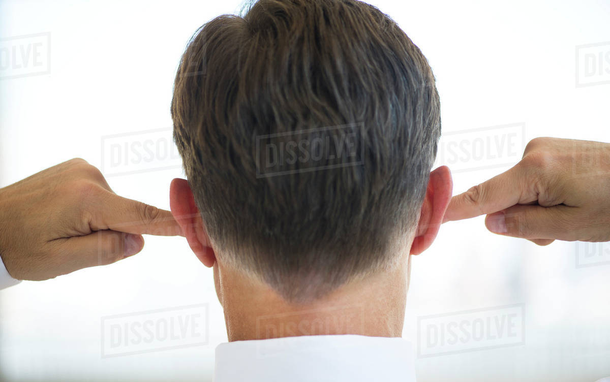 Businessman plugging ears - Royalty-free Stock Photo | Dissolve