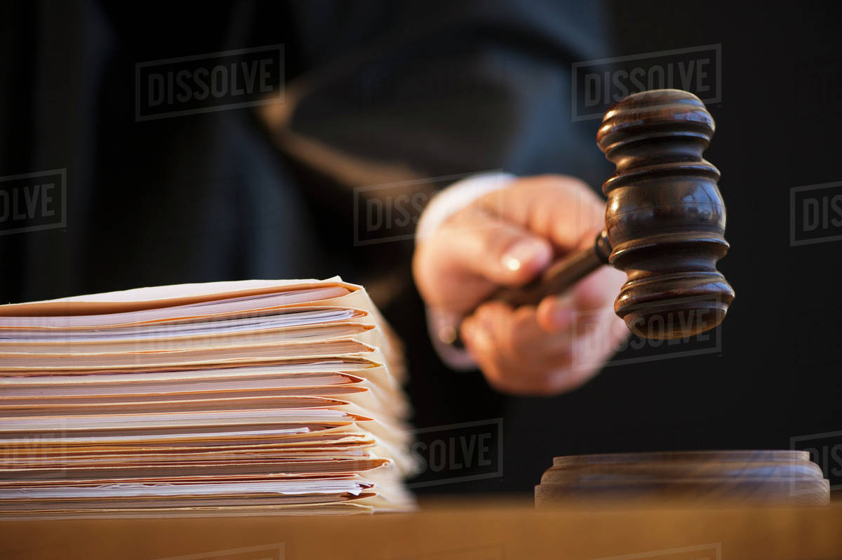 Judge holding gavel, close-up - Stock Photo - Dissolve