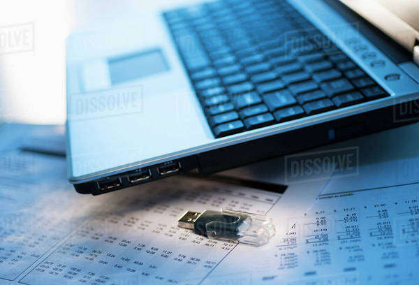 Studio shot of laptop with memory stick - Stock Photo - Dissolve