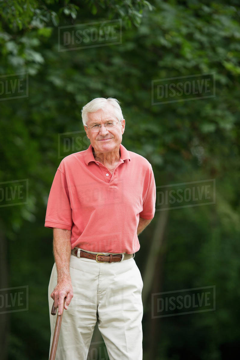 Senior man standing in park - Stock Photo - Dissolve