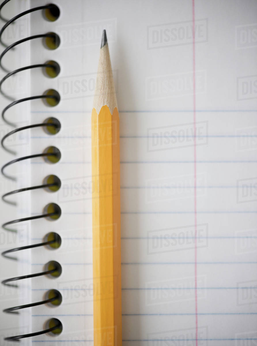 Close-up of pencil and notebook - Stock Photo - Dissolve