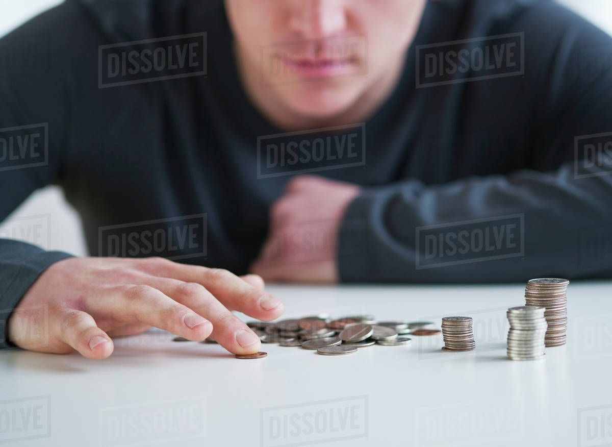 Man counting coins - Royalty-free Stock Photo | Dissolve