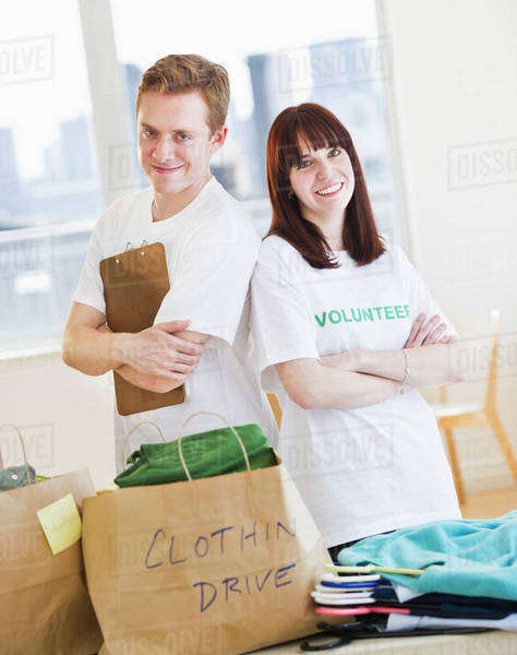 Portrait of volunteers organizing clothing drive - Royalty-free Stock ...