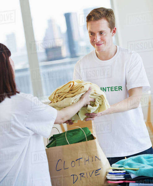 Volunteers organizing clothing drive - Royalty-free Stock Photo | Dissolve