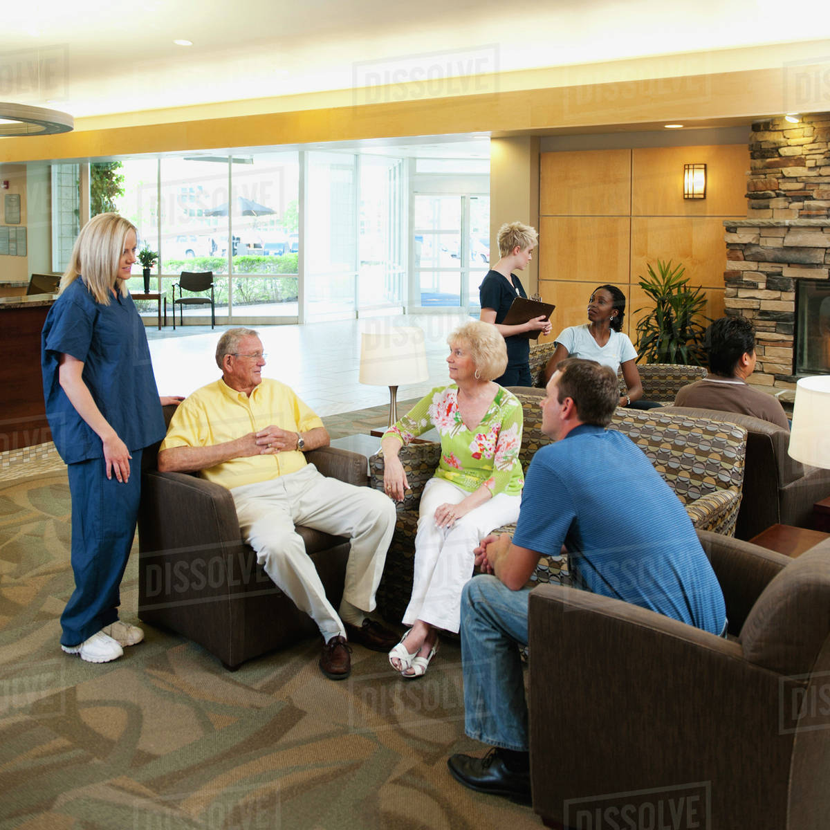 People in hospital's hall talking - Stock Photo - Dissolve