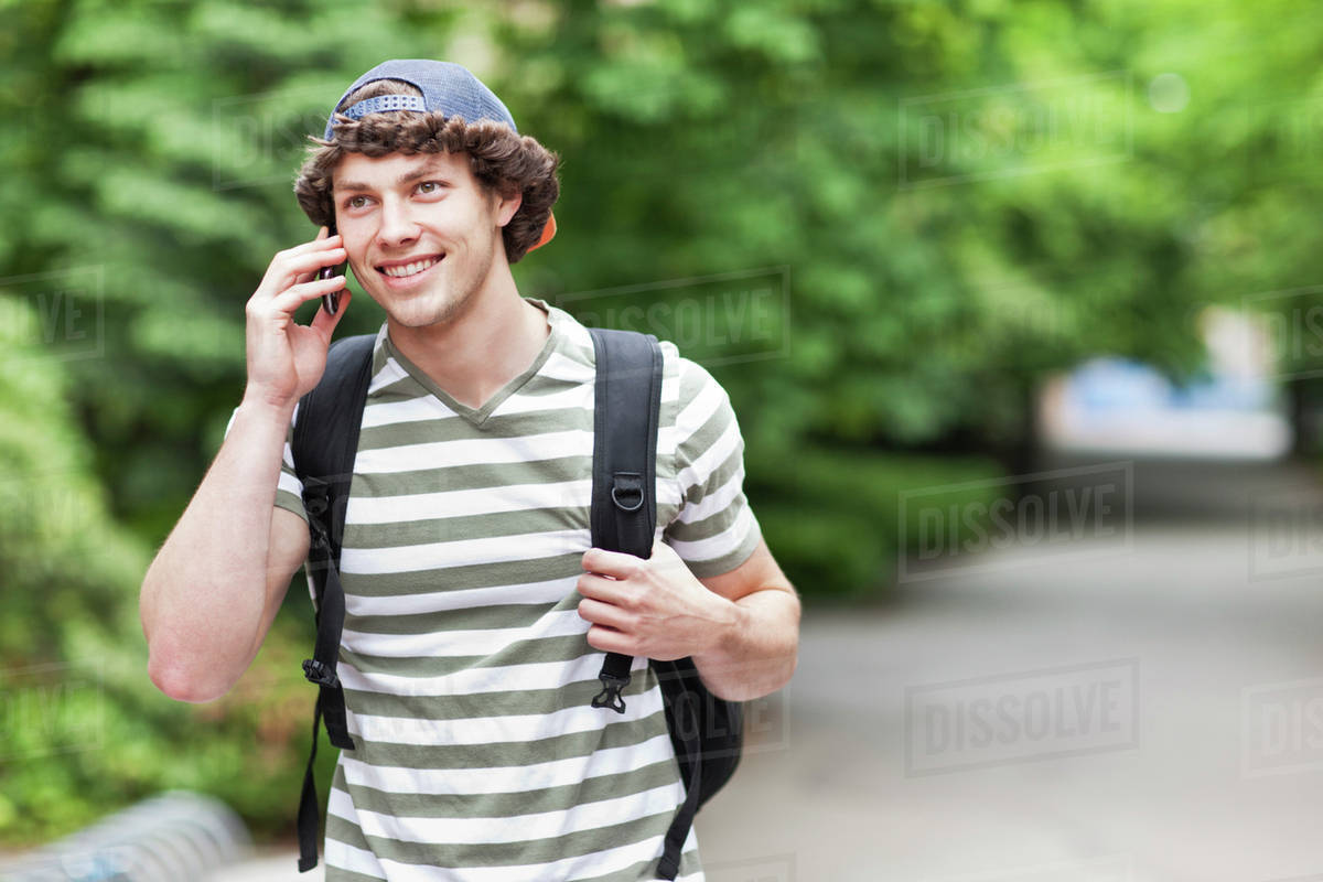 Male college student talking on cell phone - Royalty-free Stock Photo ...