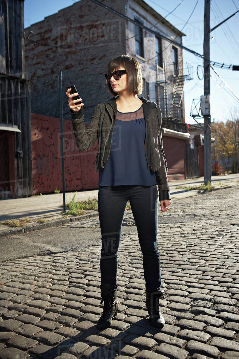 USA, New York City, Brooklyn, woman in street using phone - Royalty ...