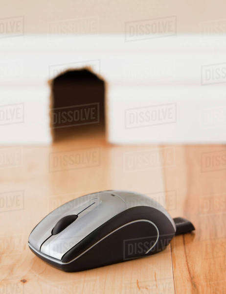 Computer mouse on floor in front of mouse hole - Royalty-free Stock ...