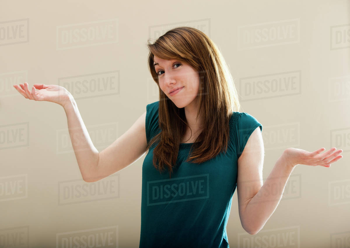 Studio portrait of young woman gesturing - Royalty-free Stock Photo ...