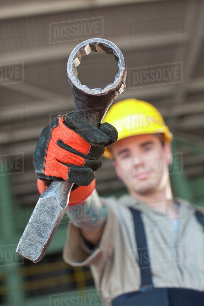 Portrait of male manual worker holding tool - Royalty-free Stock Photo ...