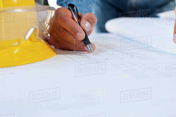 Architect's hand drawing blueprint - Royalty-free Stock Photo | Dissolve