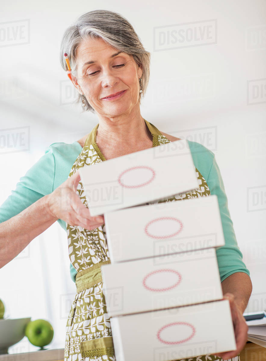 Portrait of woman carrying boxes - Royalty-free Stock Photo | Dissolve