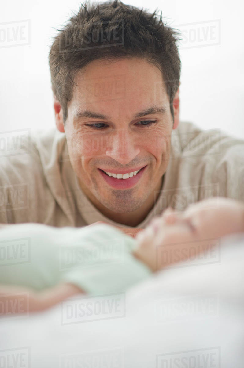 Father smiling at baby - Royalty-free Stock Photo | Dissolve