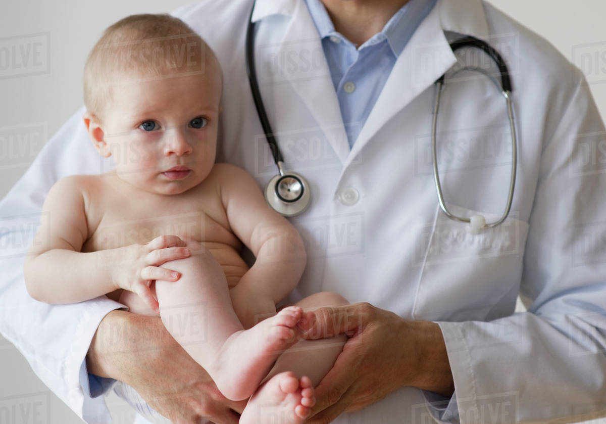 Doctor holding baby - Stock Photo - Dissolve