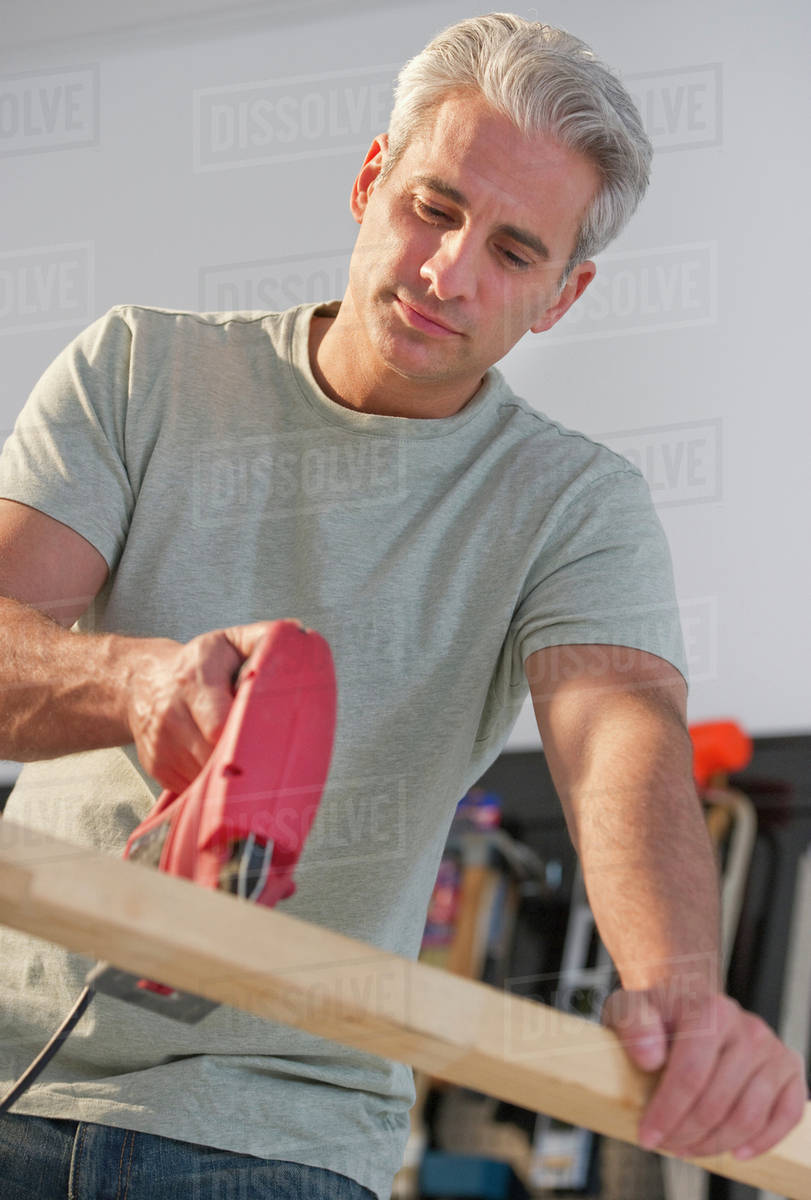 Handyman using an electric drill - Royalty-free Stock Photo | Dissolve