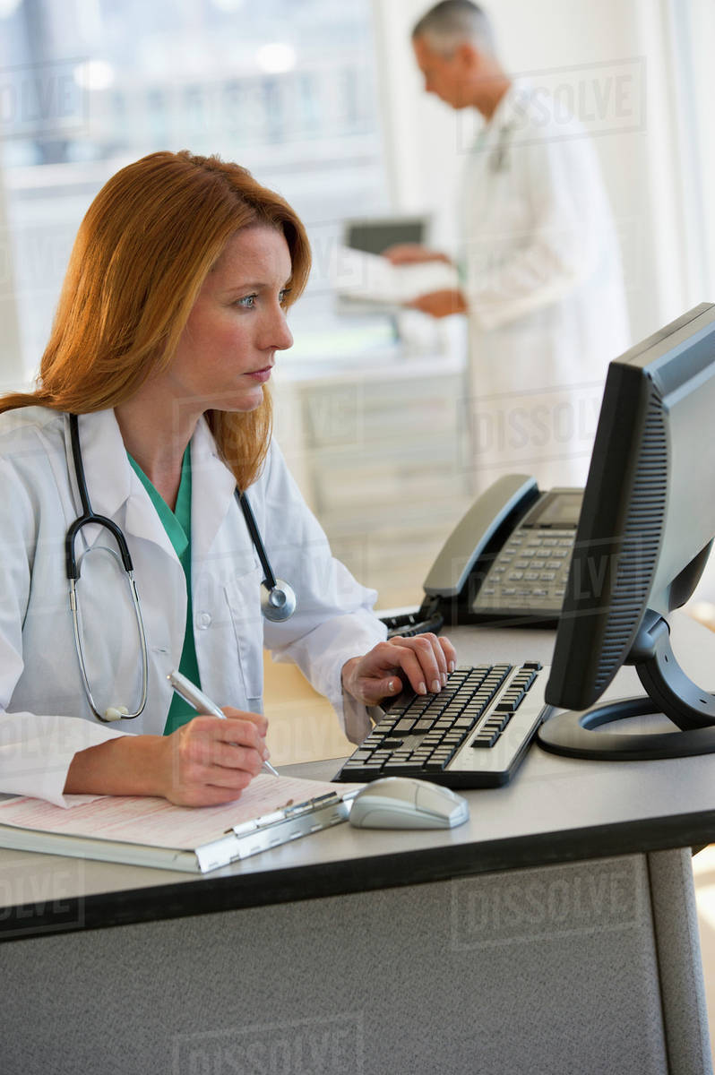 Doctor working on computer - Royalty-free Stock Photo | Dissolve
