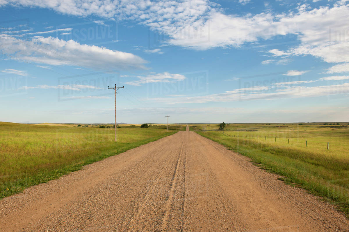 Dirt road crossing prairie - Royalty-free Stock Photo | Dissolve