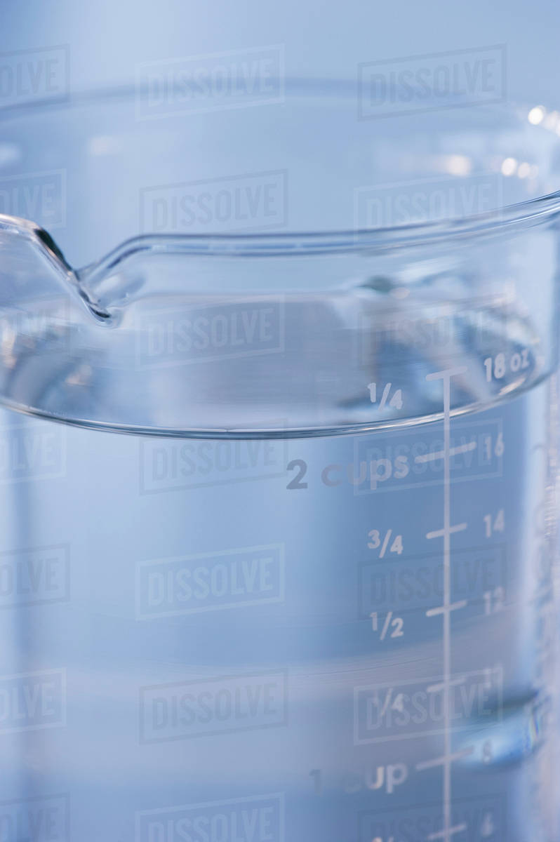Measuring cup full of water - Royalty-free Stock Photo | Dissolve