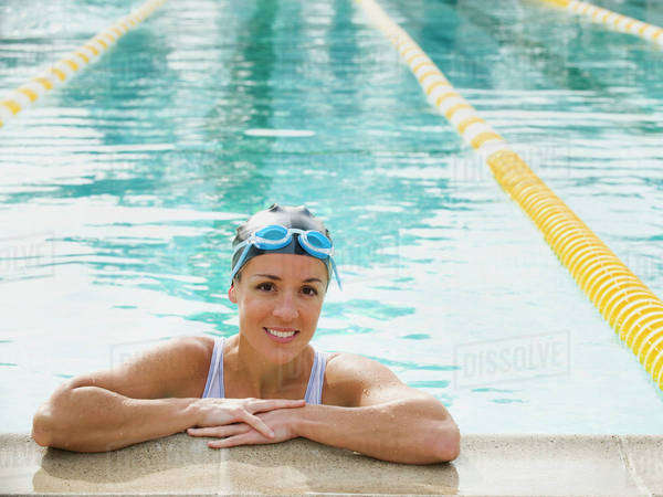 Woman resting after swimming laps - Royalty-free Stock Photo | Dissolve