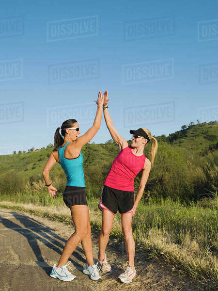 Two trail runners giving each other a high five - Royalty-free Stock ...