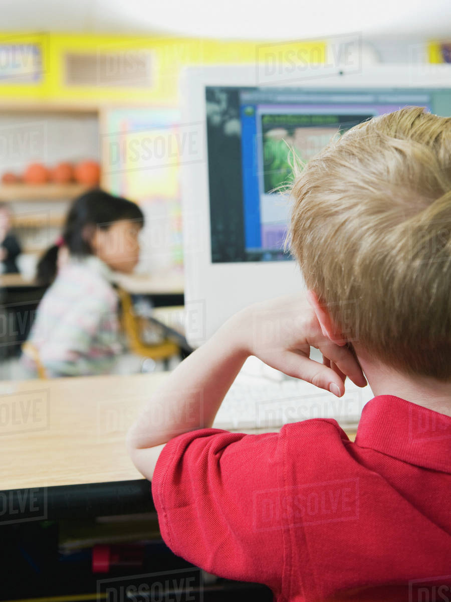 Elementary students working on computers - Stock Photo - Dissolve