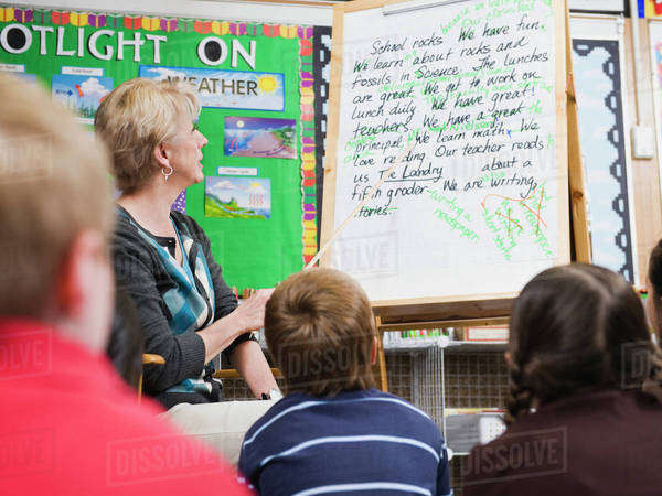 Teacher giving classroom presentation to students - Stock Photo - Dissolve