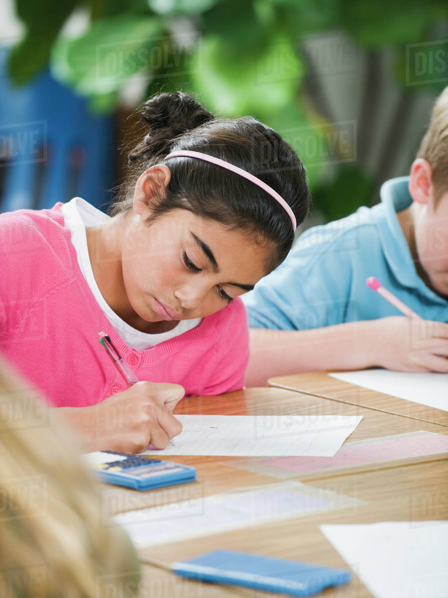 Students doing math work in classroom - Stock Photo - Dissolve