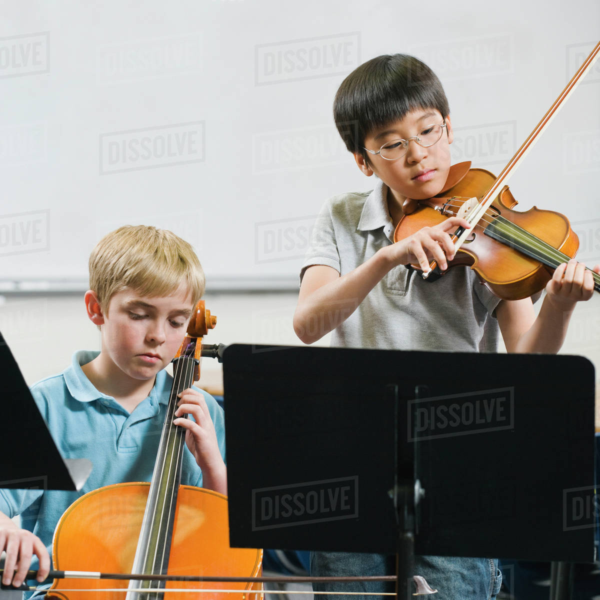 Elementary school students playing instruments in music class - Royalty ...