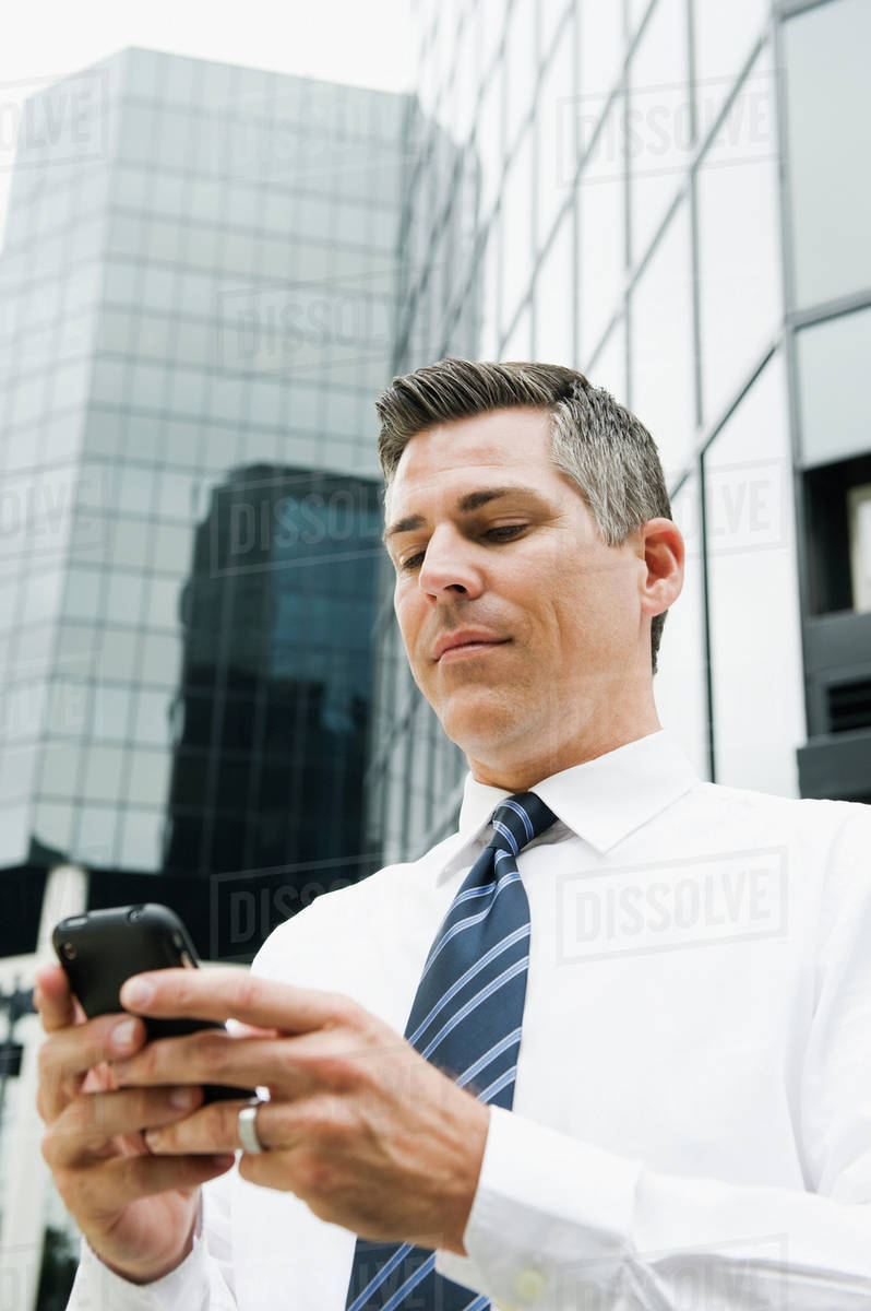 Businessman texting - Royalty-free Stock Photo | Dissolve