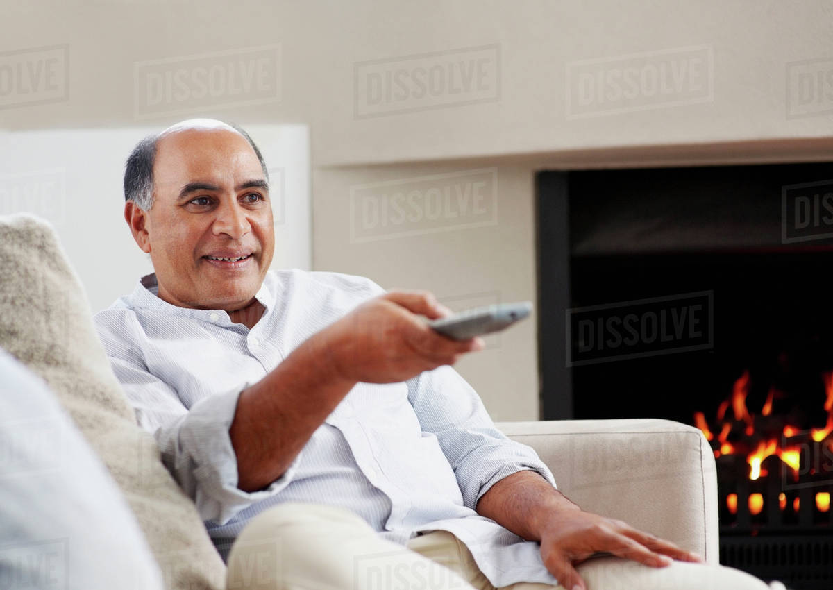 Man watching television - Stock Photo - Dissolve