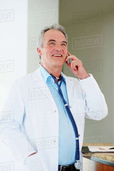 Doctor talking on phone - Stock Photo - Dissolve