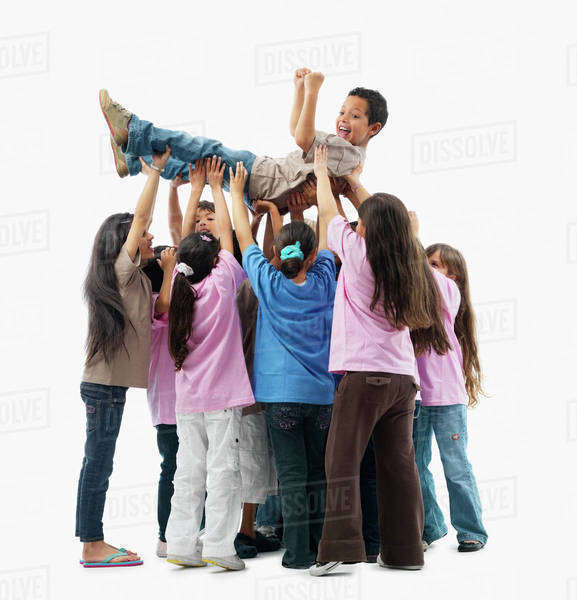 Children lifting one child - Stock Photo - Dissolve