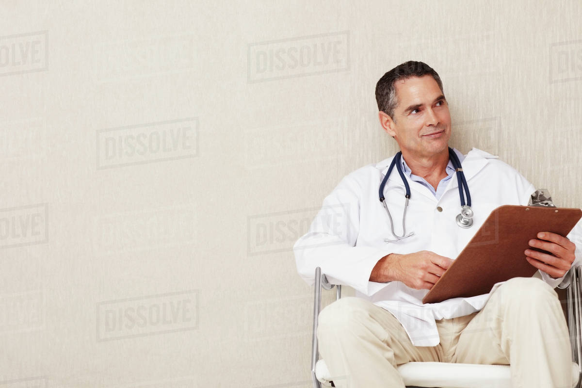 Doctor sitting in waiting room - Royalty-free Stock Photo | Dissolve
