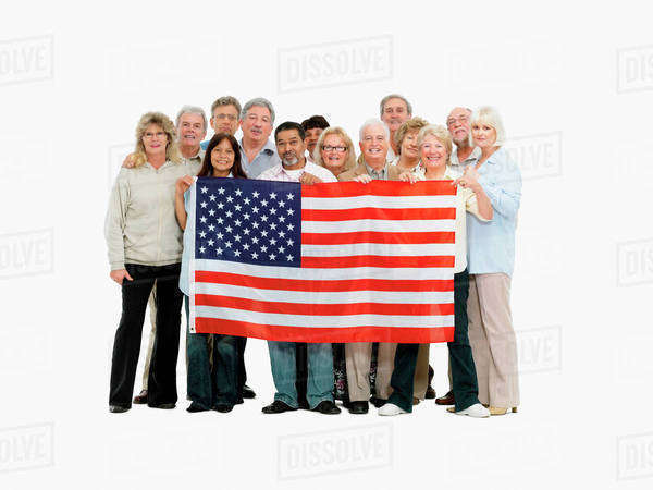 Group of people holding an American flag - Stock Photo - Dissolve
