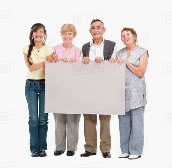 Four people holding a blank poster - Royalty-free Stock Photo | Dissolve