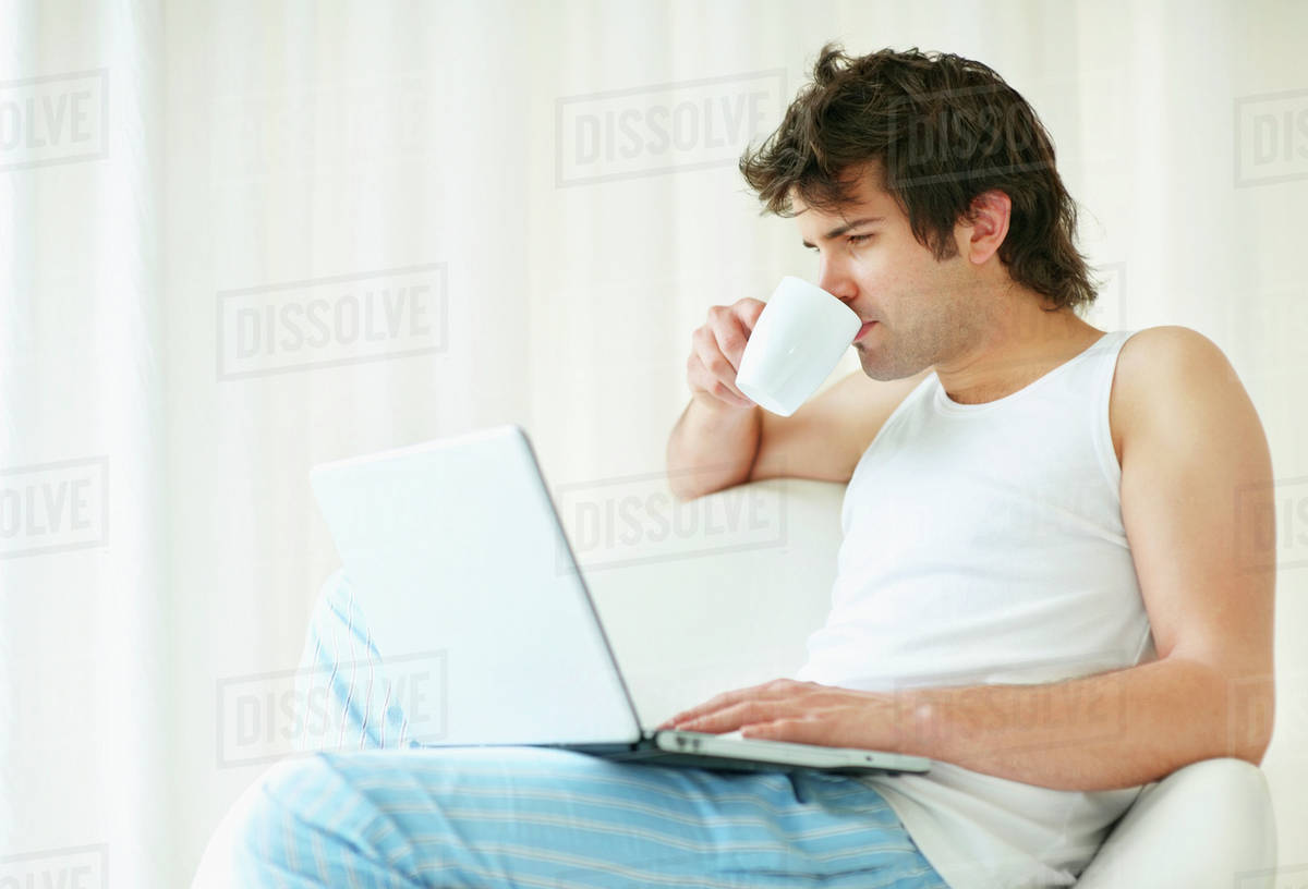 Relaxed man browsing the internet - Stock Photo - Dissolve