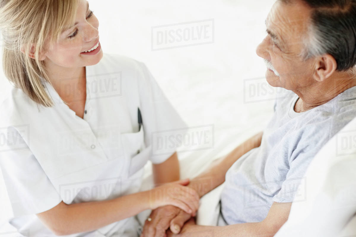 Nurse sitting with patient - Royalty-free Stock Photo | Dissolve