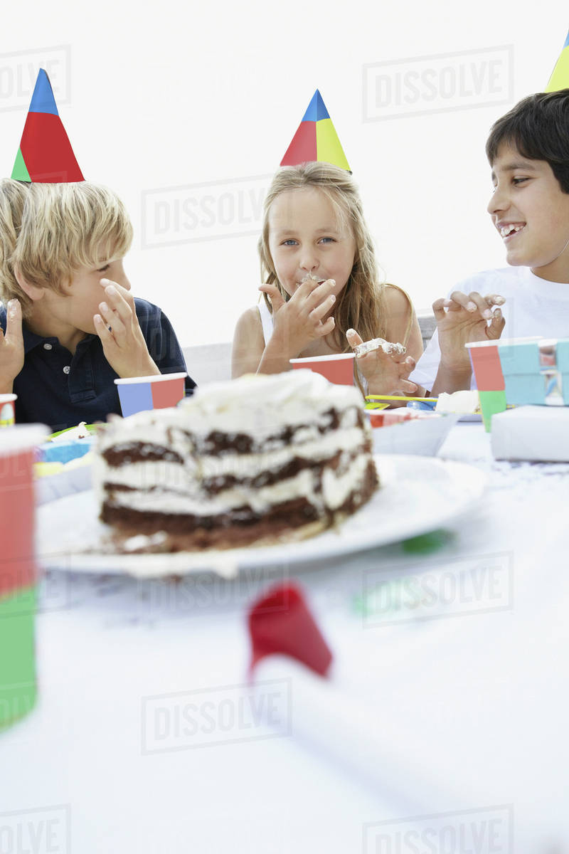 Children eating birthday cake - Royalty-free Stock Photo | Dissolve