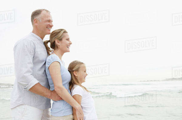 Family standing on beach - Royalty-free Stock Photo | Dissolve