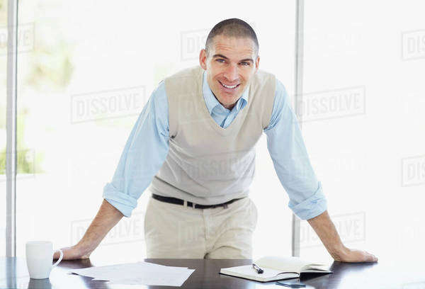 Cheerful office worker with hands behind back - Royalty-free Stock ...