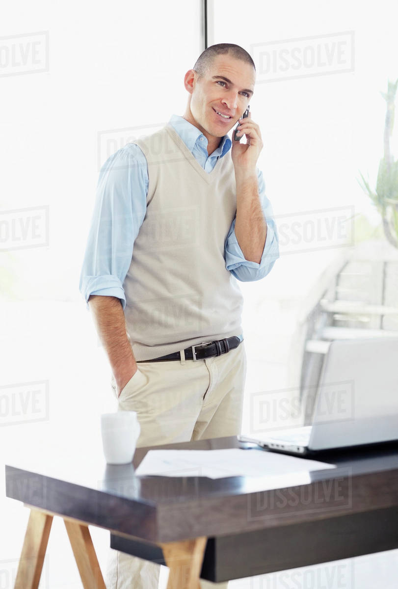Office worker using mobile phone - Royalty-free Stock Photo | Dissolve