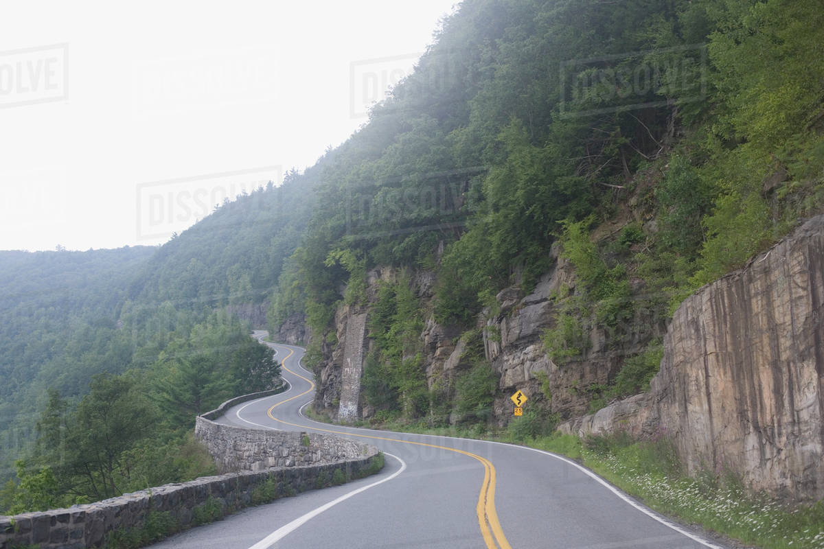 Winding road through mountains - Stock Photo - Dissolve