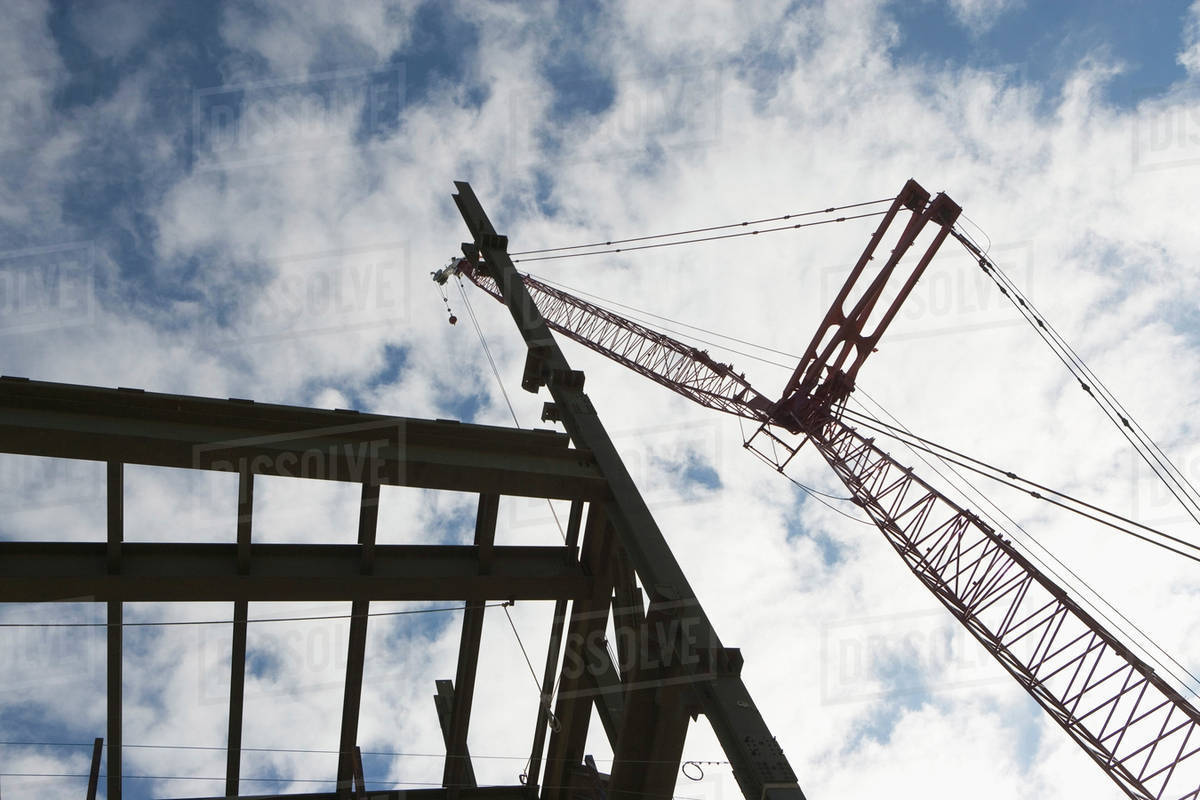 Upward view of crane and construction - Stock Photo - Dissolve
